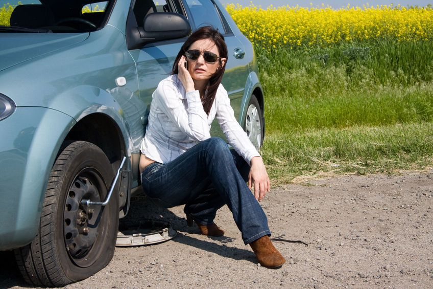 Woman with flat tire calling for help - Tires Easy Content Hub